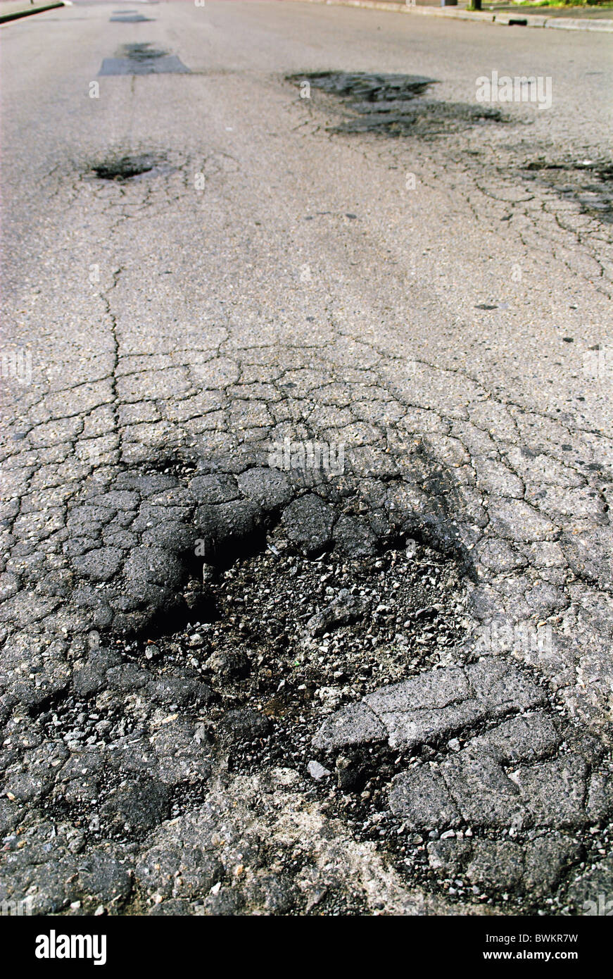 street holes blow holes paving asphalt street tar holes Stock Photo - Alamy