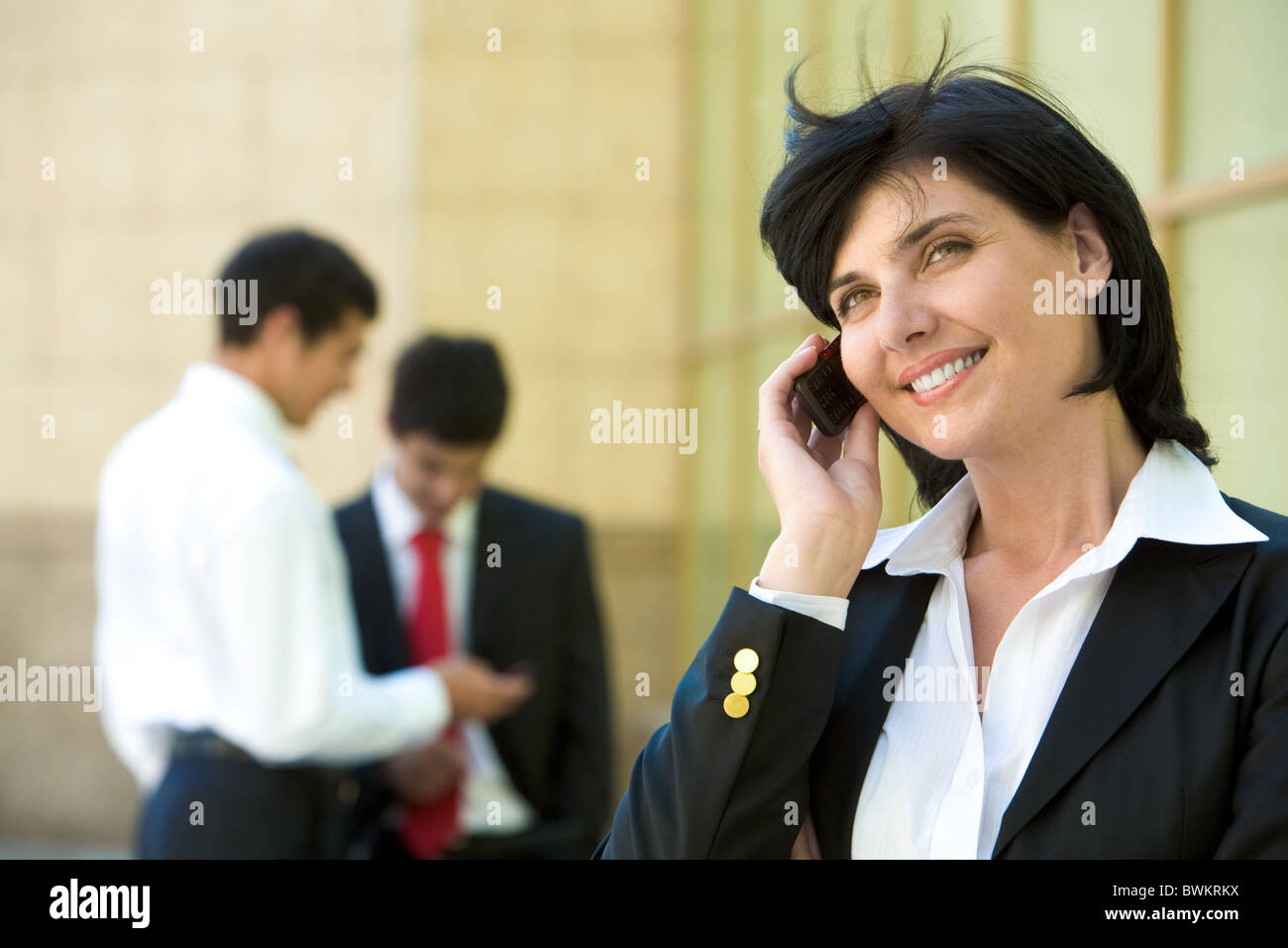 Portrait of pretty boss talking by mobile phone with smile Stock Photo ...