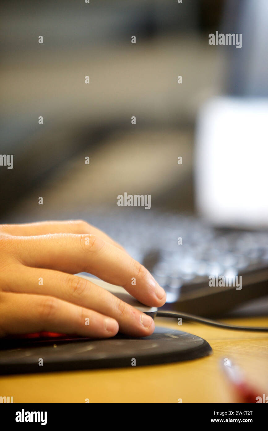 Someone using a computer mouse with their right hand in an office Stock ...