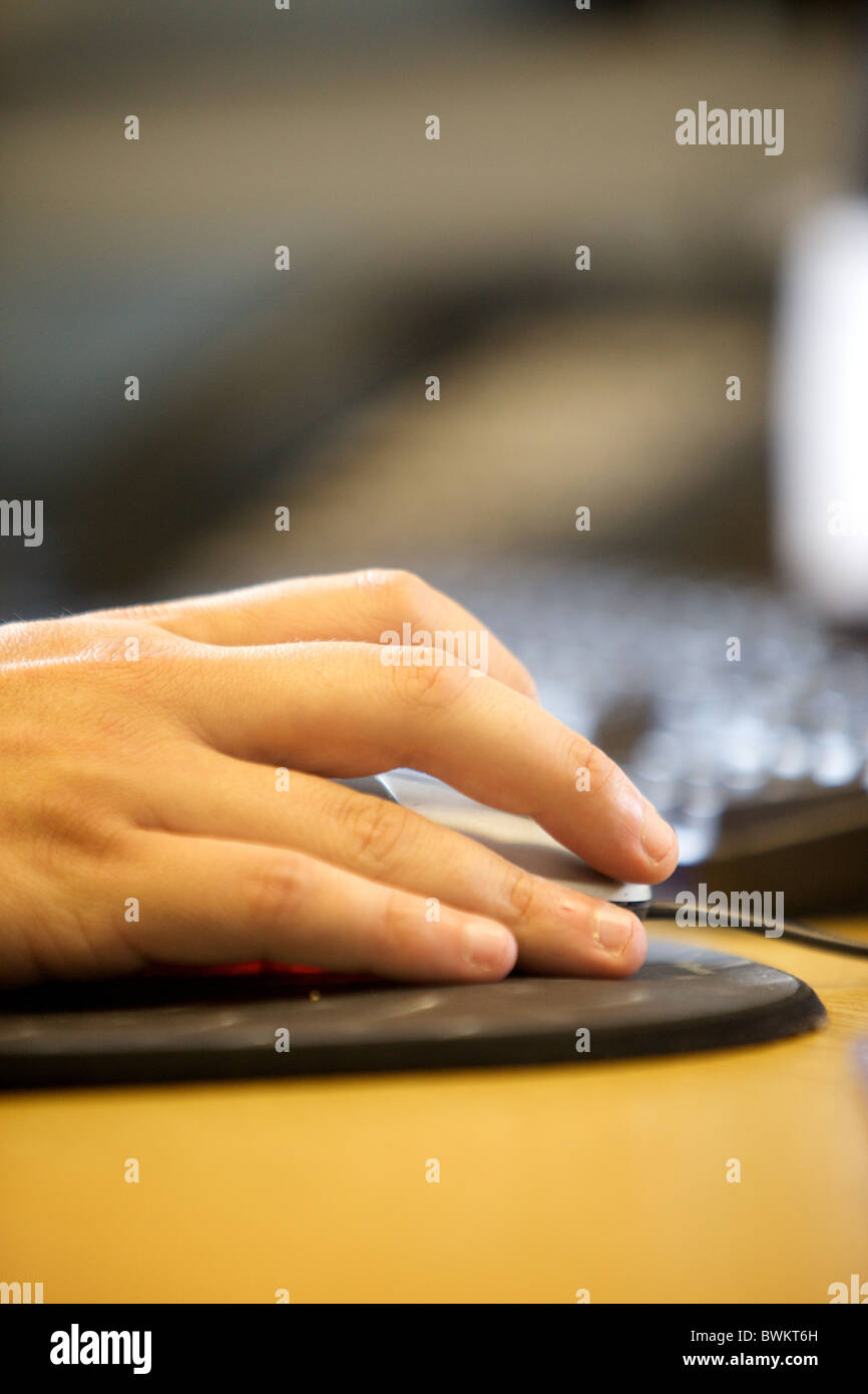 Someone using a computer mouse with their right hand in an office Stock ...