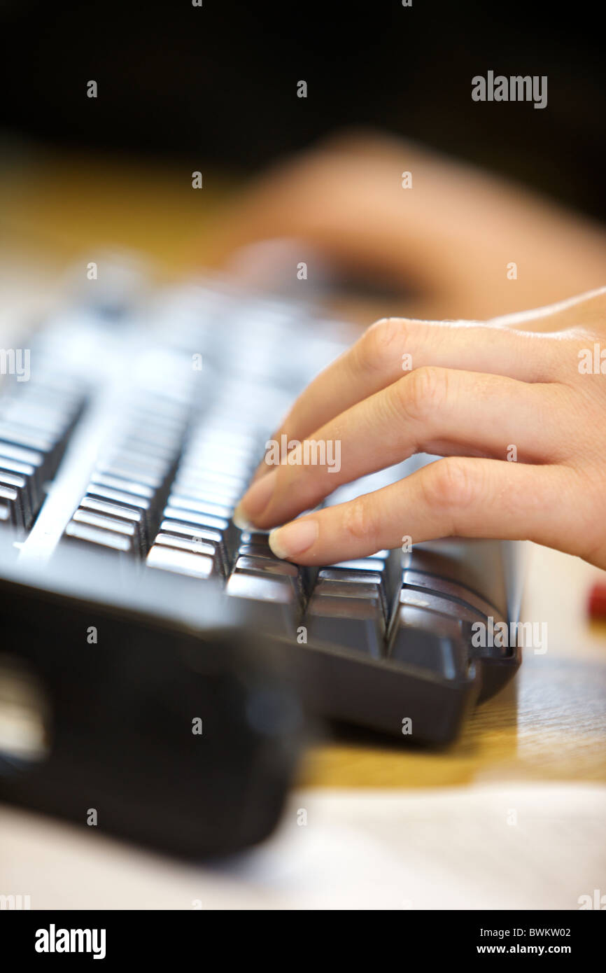 Fingers typing on a keyboard in an office Stock Photo - Alamy