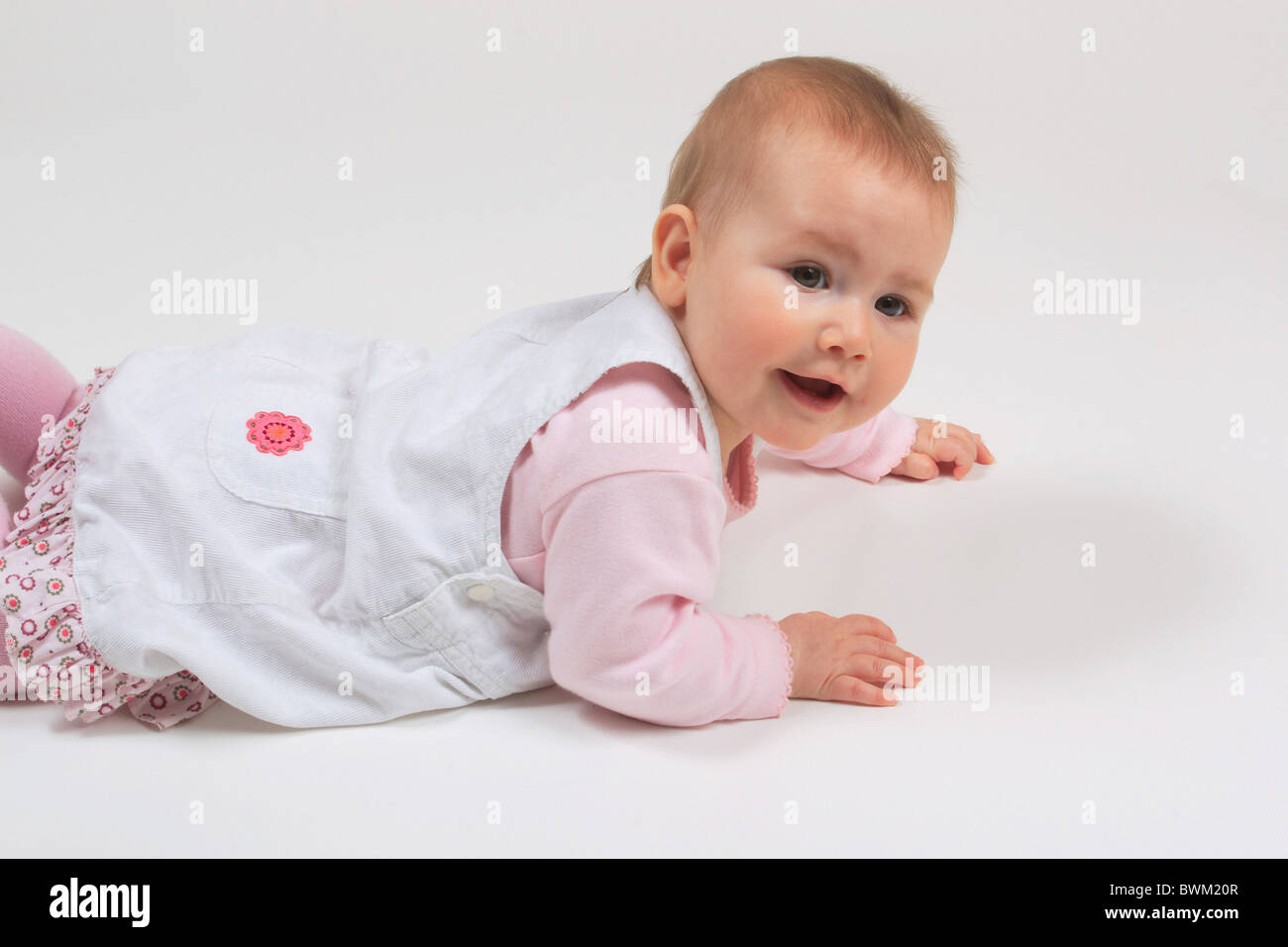 Baby Lying on tummy Smiling Studio shot Stock Photo - Alamy