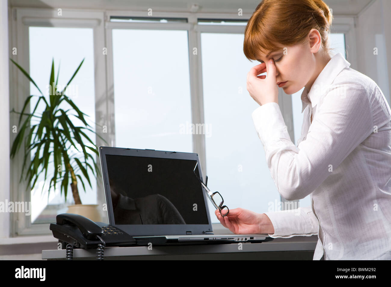 Portrait of tired businesswoman with his eyeglasses off keeping his ...