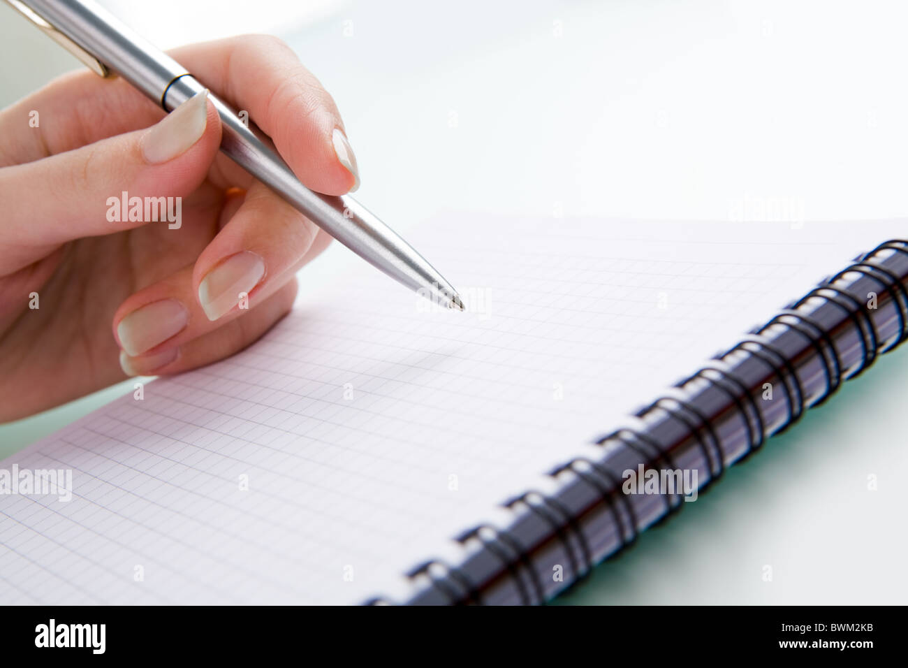 Image of hand with pen over notepad Stock Photo - Alamy