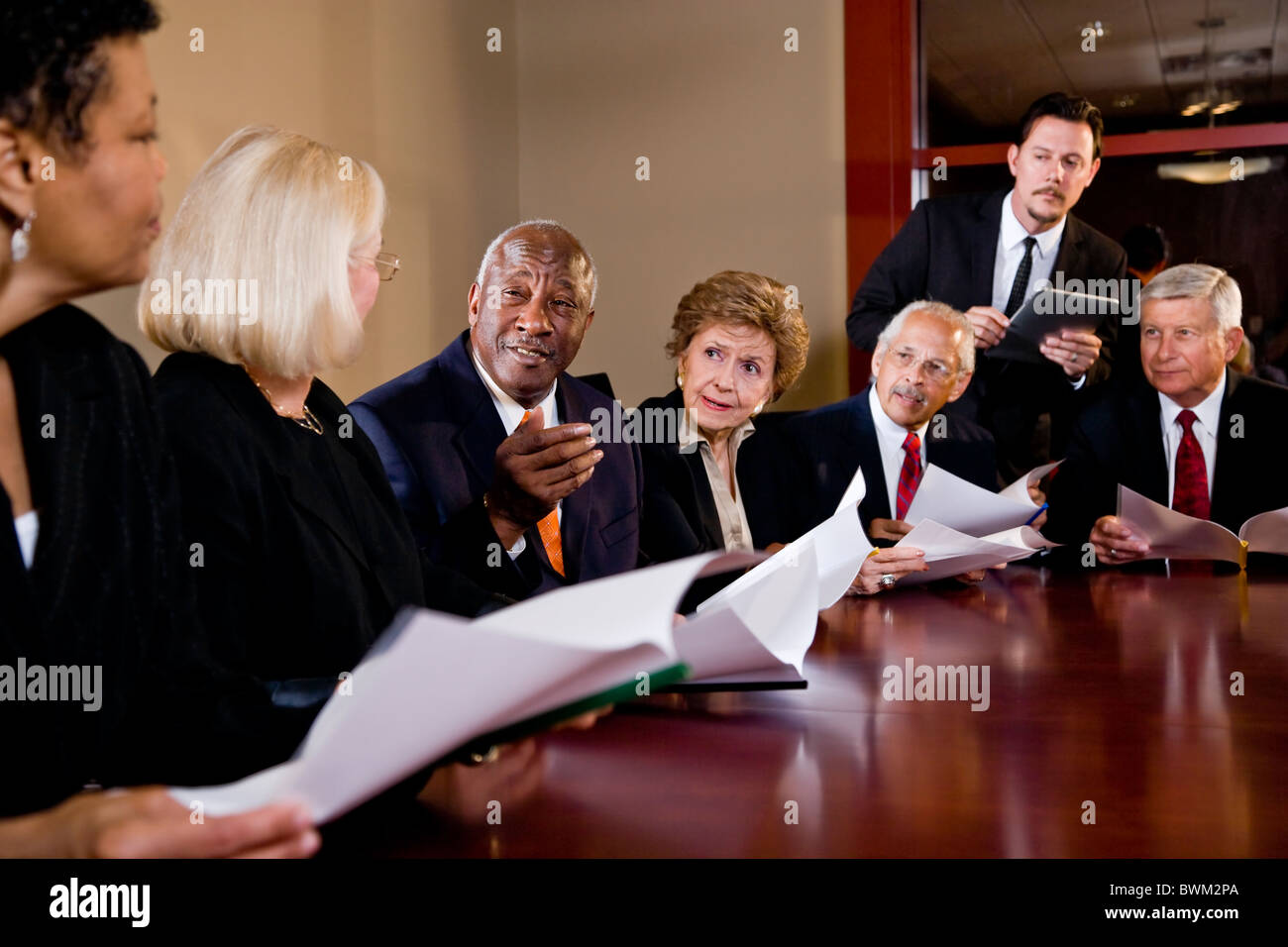 Manager presenting to group of senior executives Stock Photo - Alamy