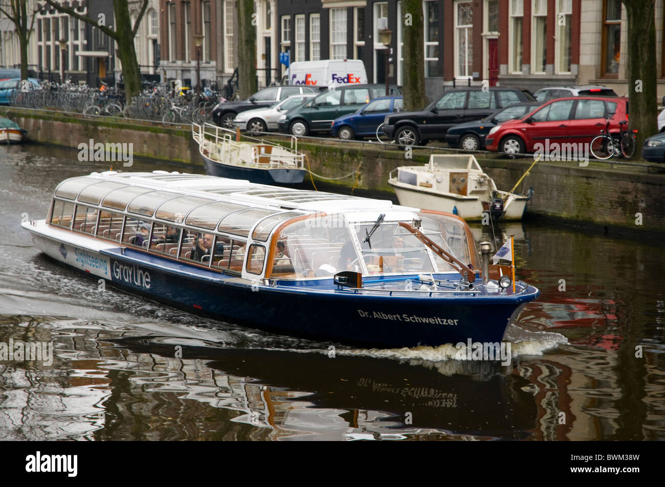 A water bus travelling along a canal in Amsterdam Stock Photo - Alamy