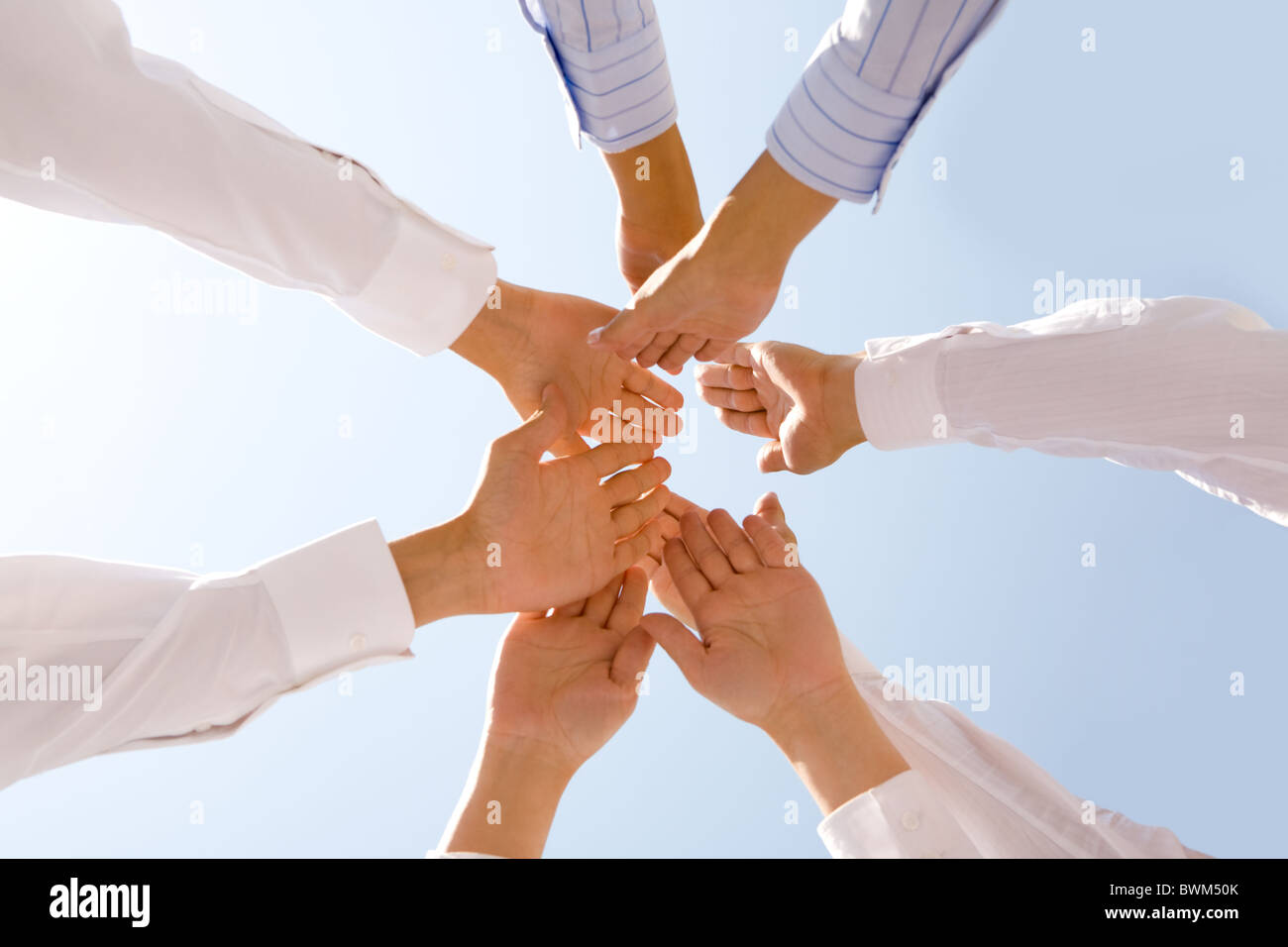 Conceptual image of human hands together with blue sky above Stock ...
