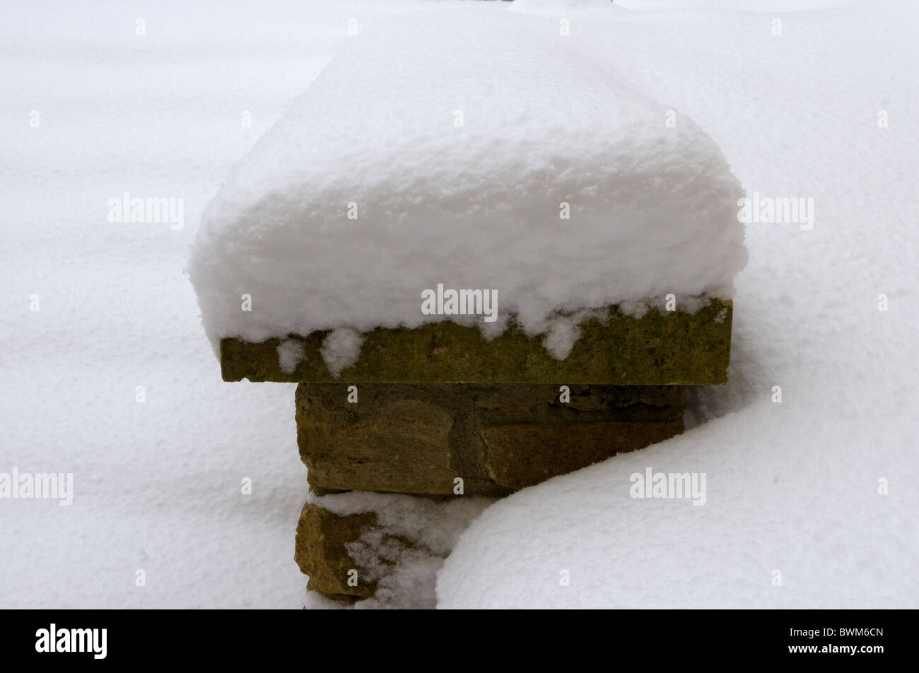 Close up of a stone wall covered in heavy snow Stock Photo - Alamy