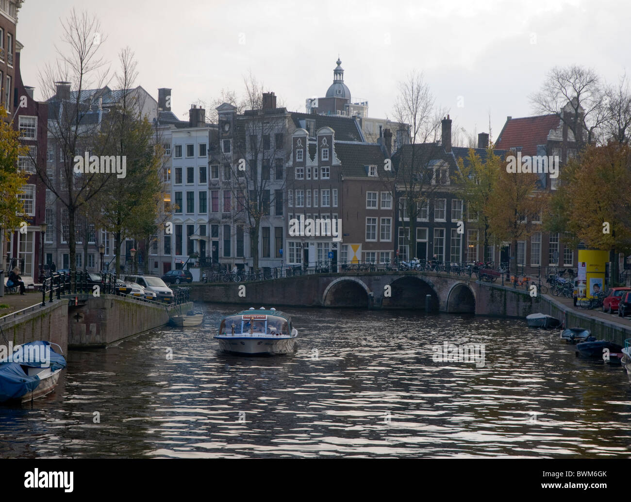 A water bus travelling along a canal in Amsterdam Stock Photo - Alamy