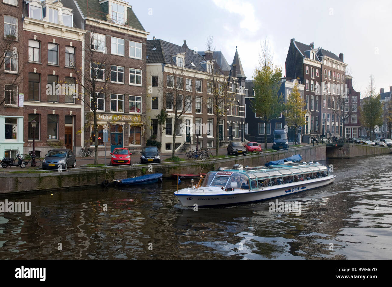 A water bus travelling along a canal in Amsterdam Stock Photo - Alamy