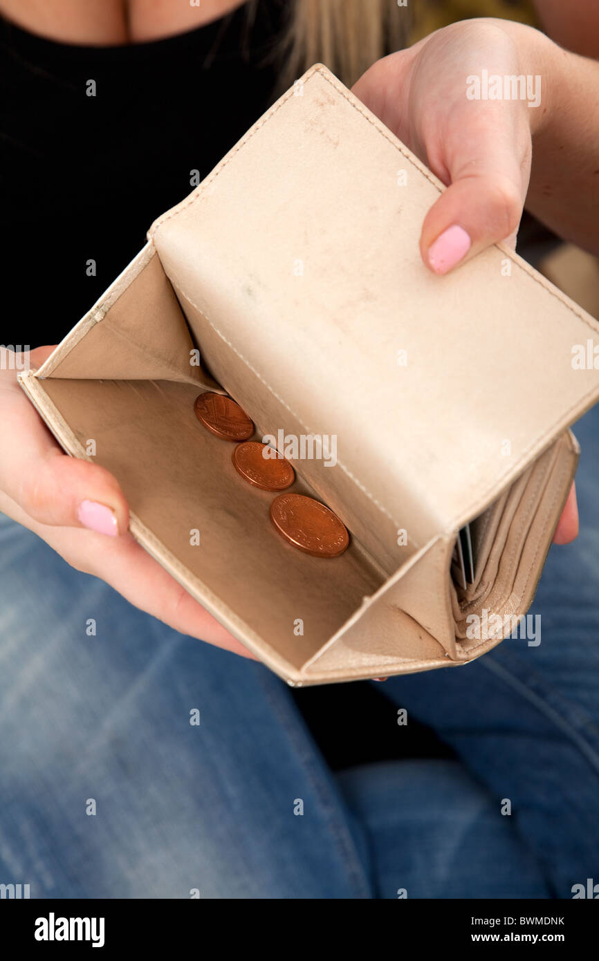 Young woman with only loose change in her purse Stock Photo - Alamy