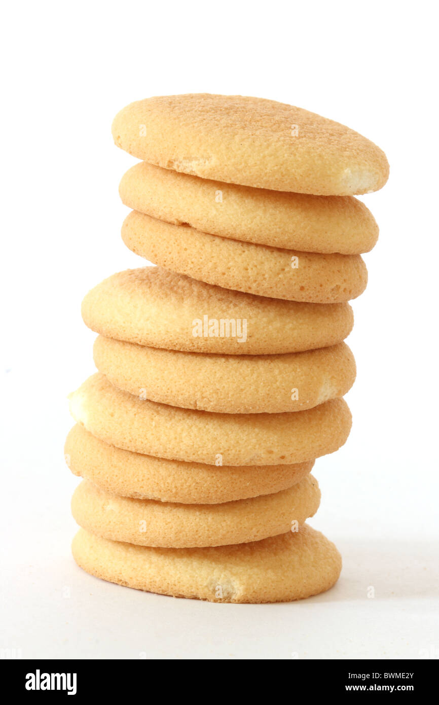 Close up view of several sponge biscuits in a stack on white background ...