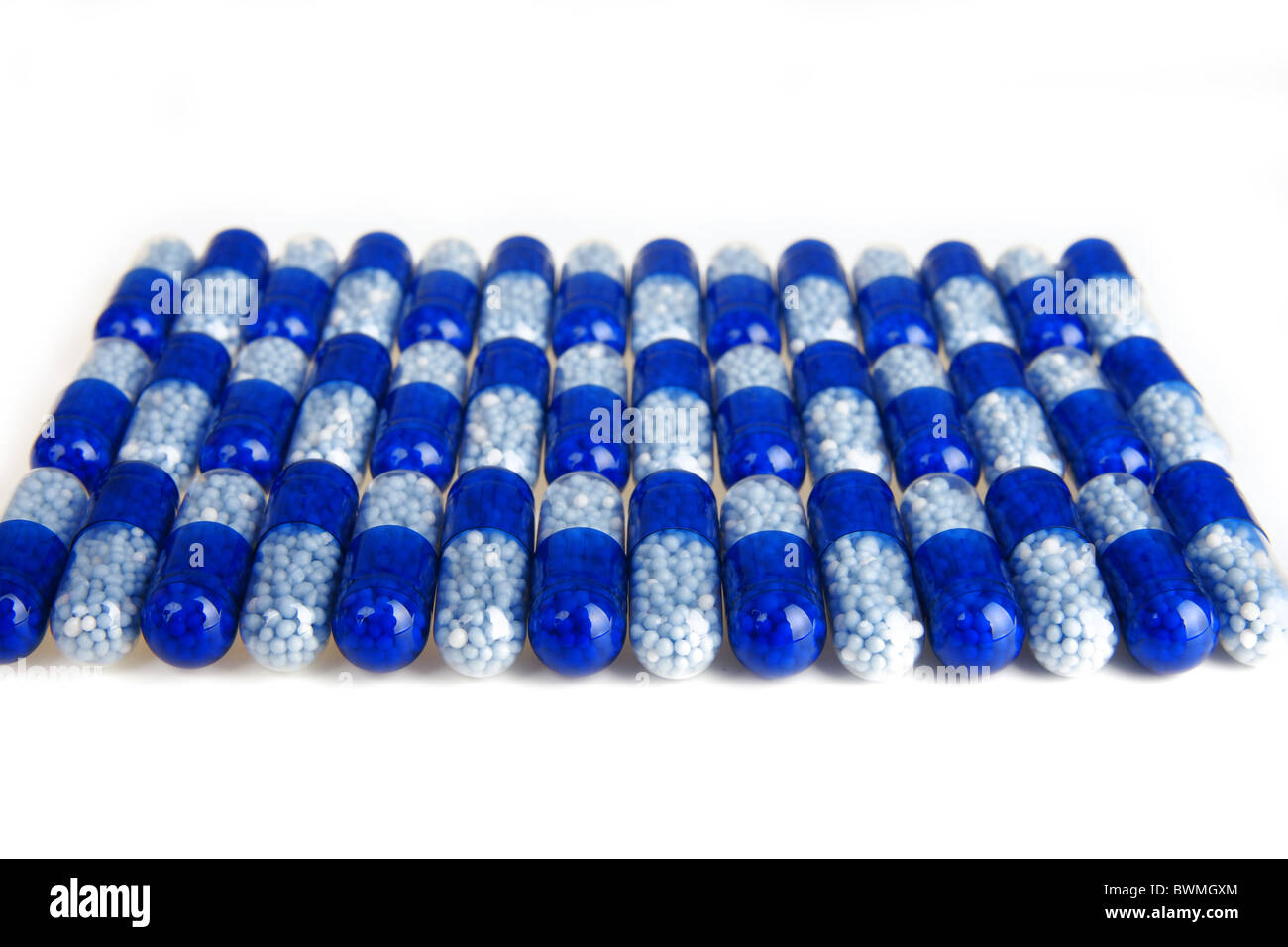 A lot of blue capsule medicine on the white background Stock Photo - Alamy