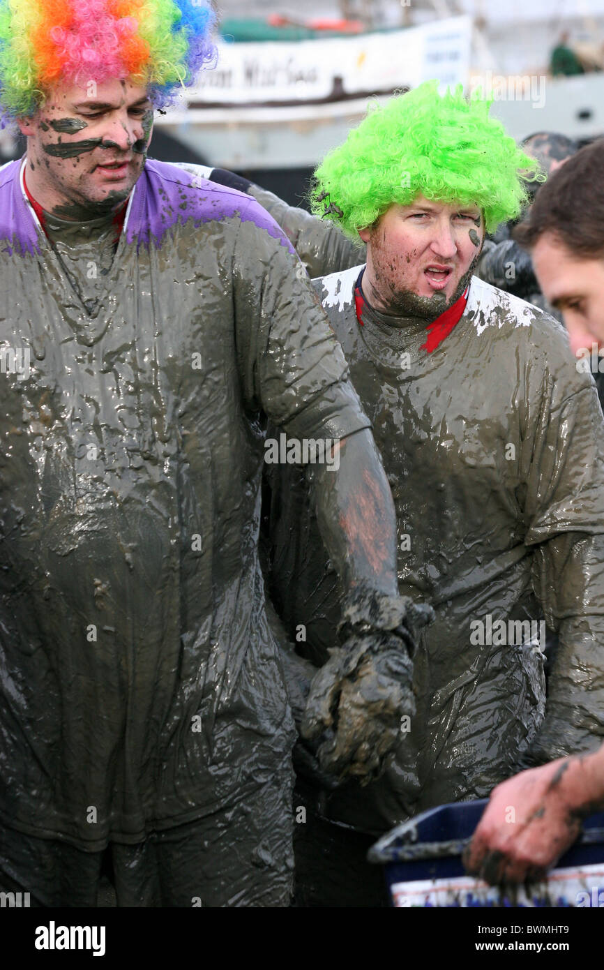 two men in wigs covered in mud after completeing the Maldon mud race ...