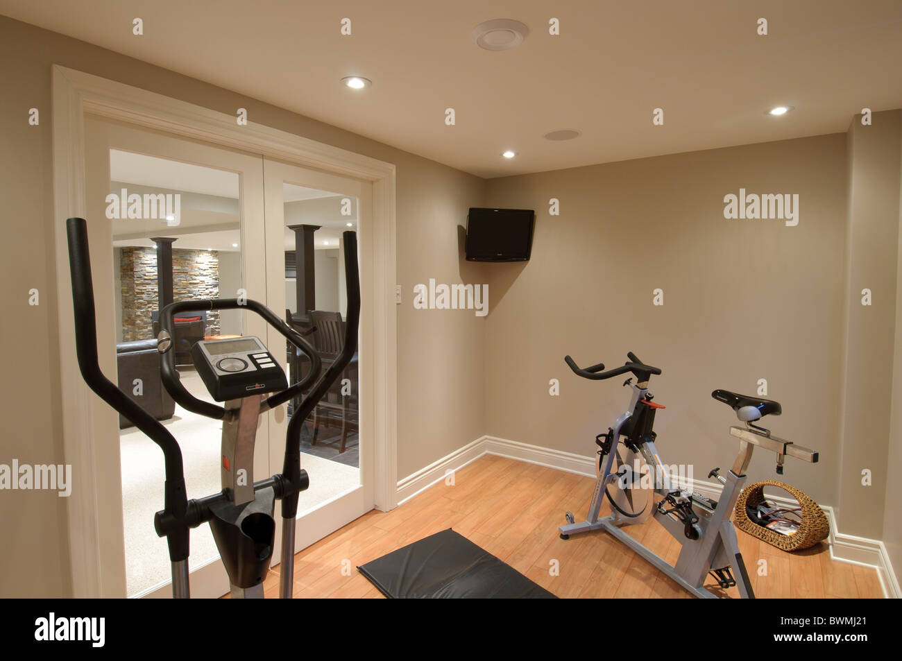 Exercise gym with equipment in a luxury residential basement Stock ...