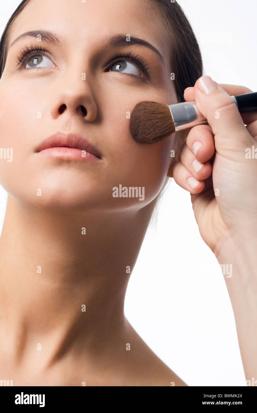 Fresh girl having makeup procedure over white background Stock Photo ...