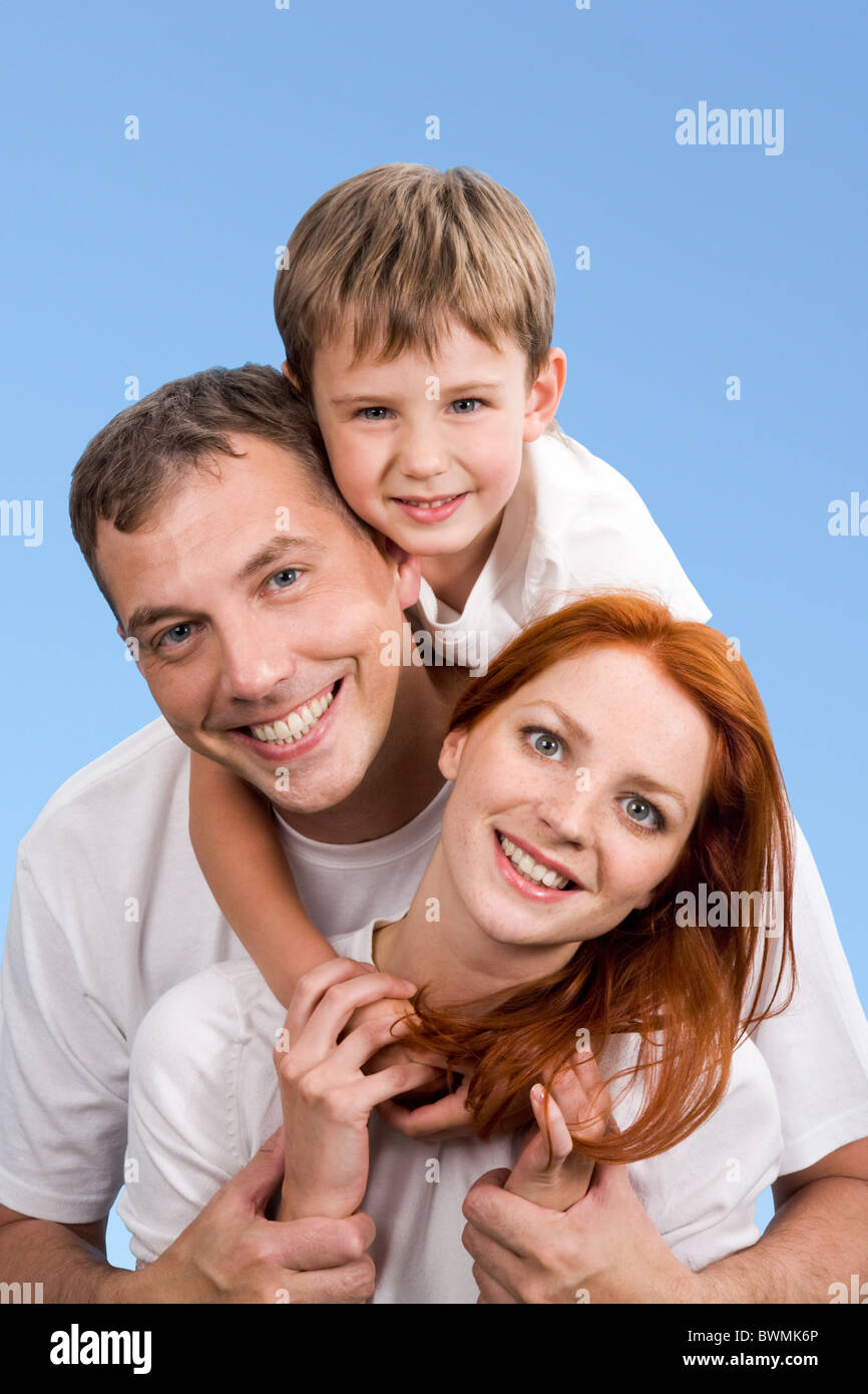 Portrait of smiling family on a blue background Stock Photo - Alamy