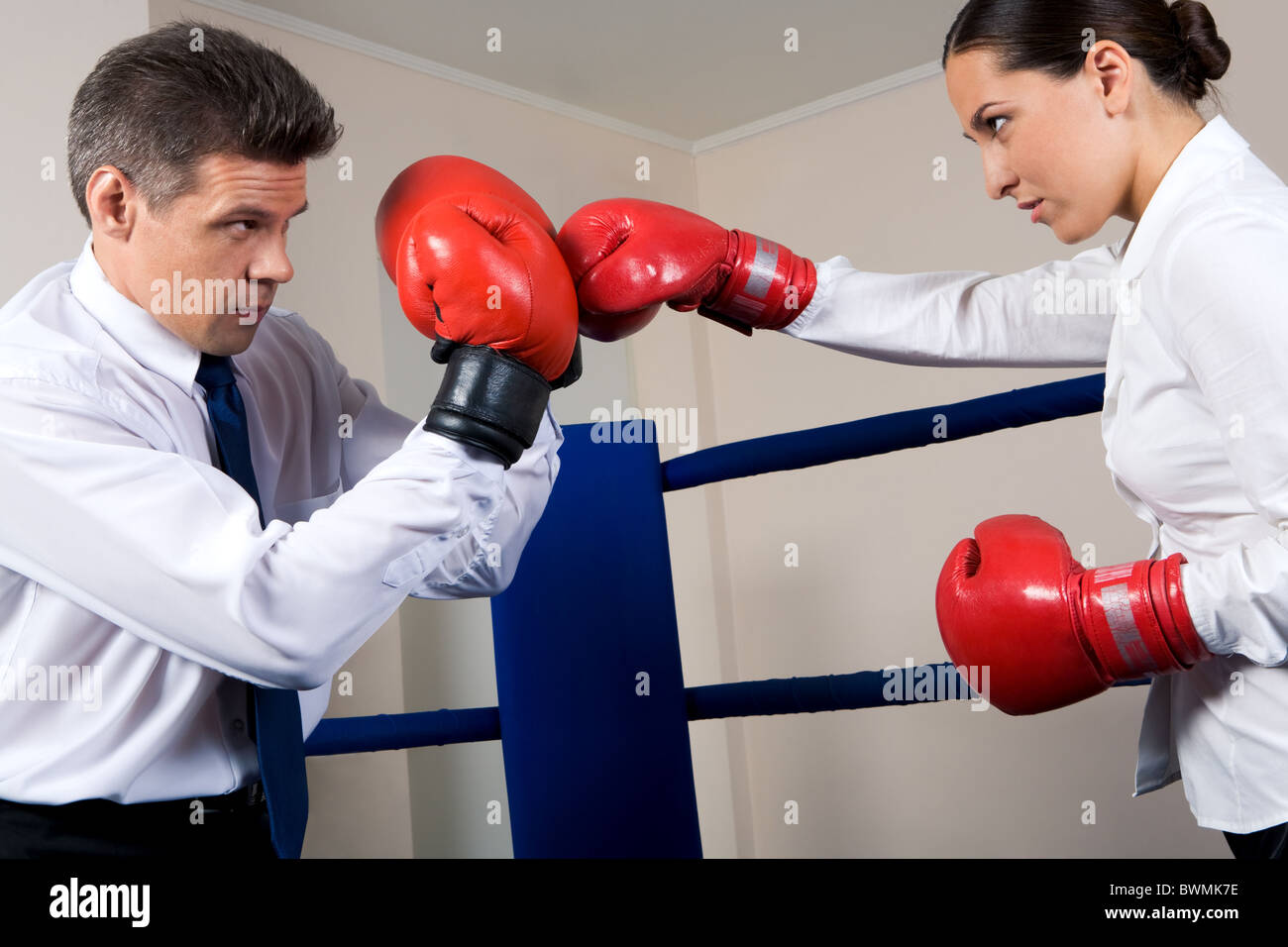 Portrait of aggressive businessman in boxing gloves fighting with ...