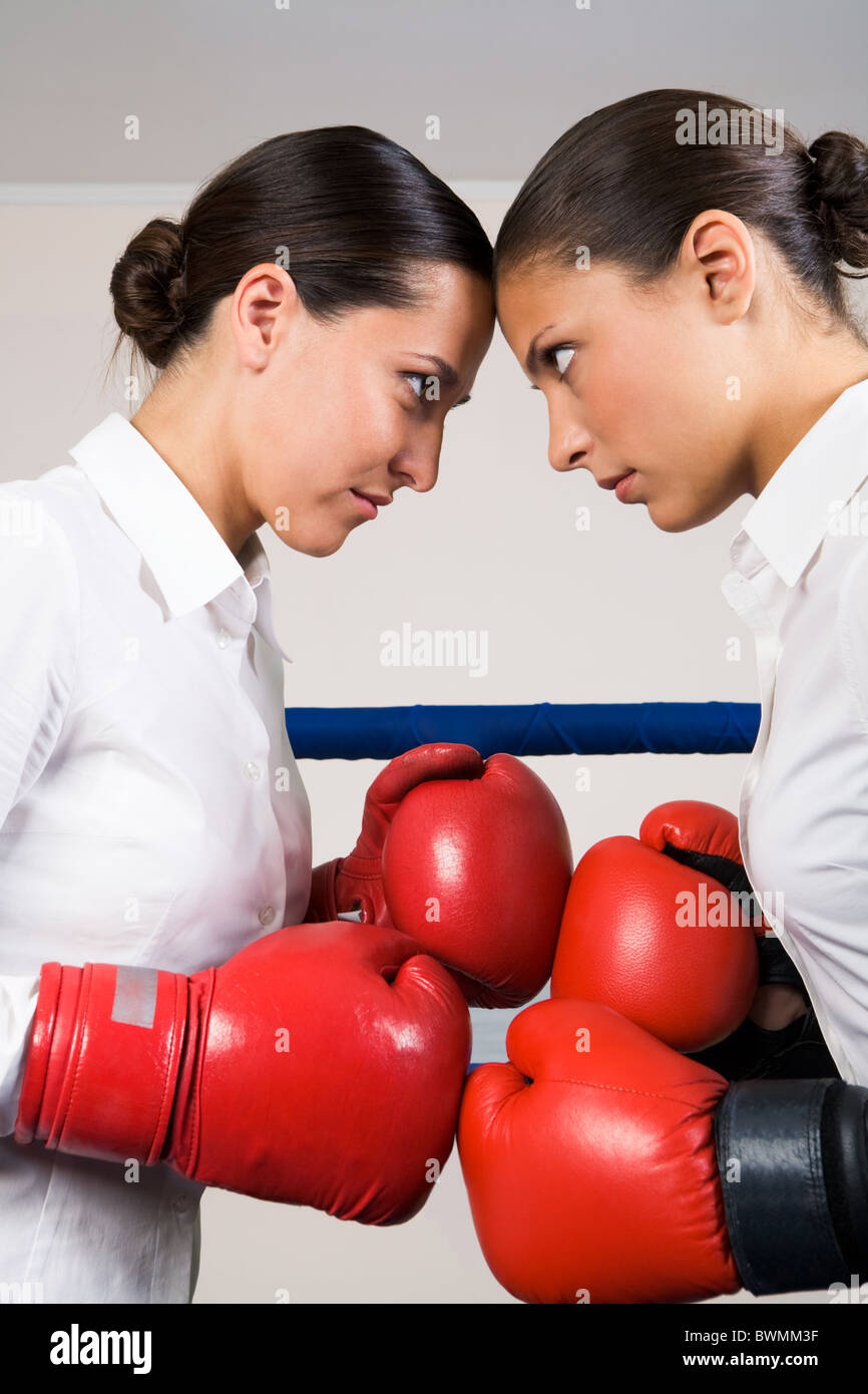 Photo of aggressive business women in boxing gloves fighting with each ...