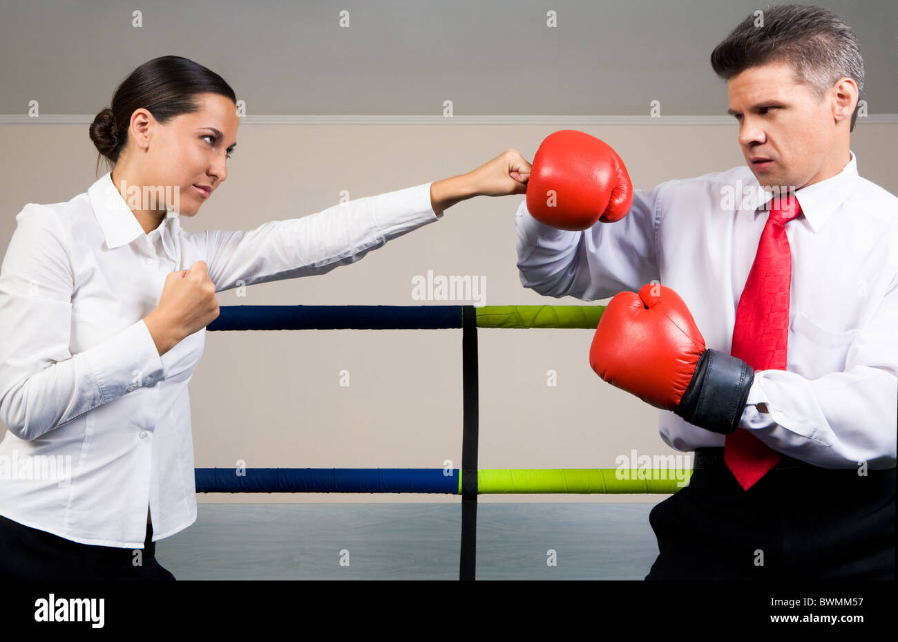 Portrait of aggressive businessman in boxing gloves fighting with ...