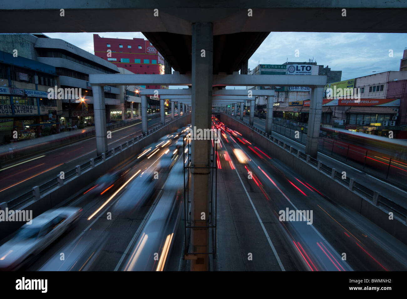 Traffic, captured with a motion blur effect, moves along a street in ...