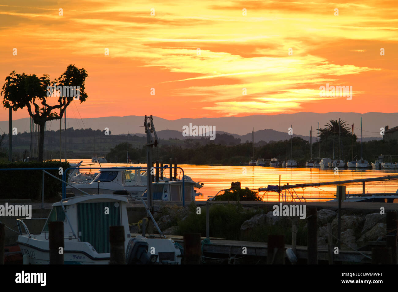 Moored Boats at Sunset in Les Cabanes de Fleury France Stock Photo - Alamy