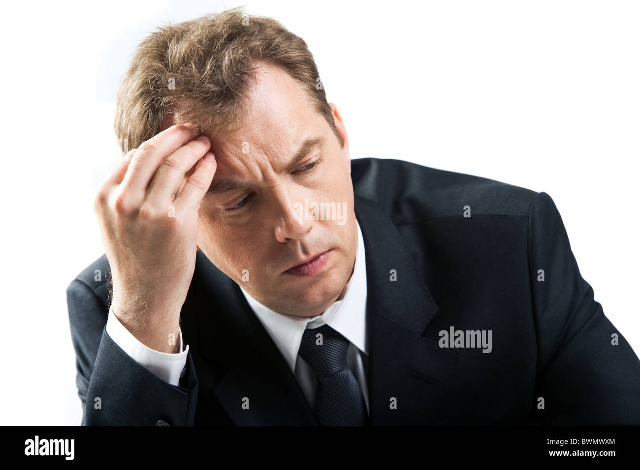 Photo of stressed businessman touching his head while thinking Stock ...
