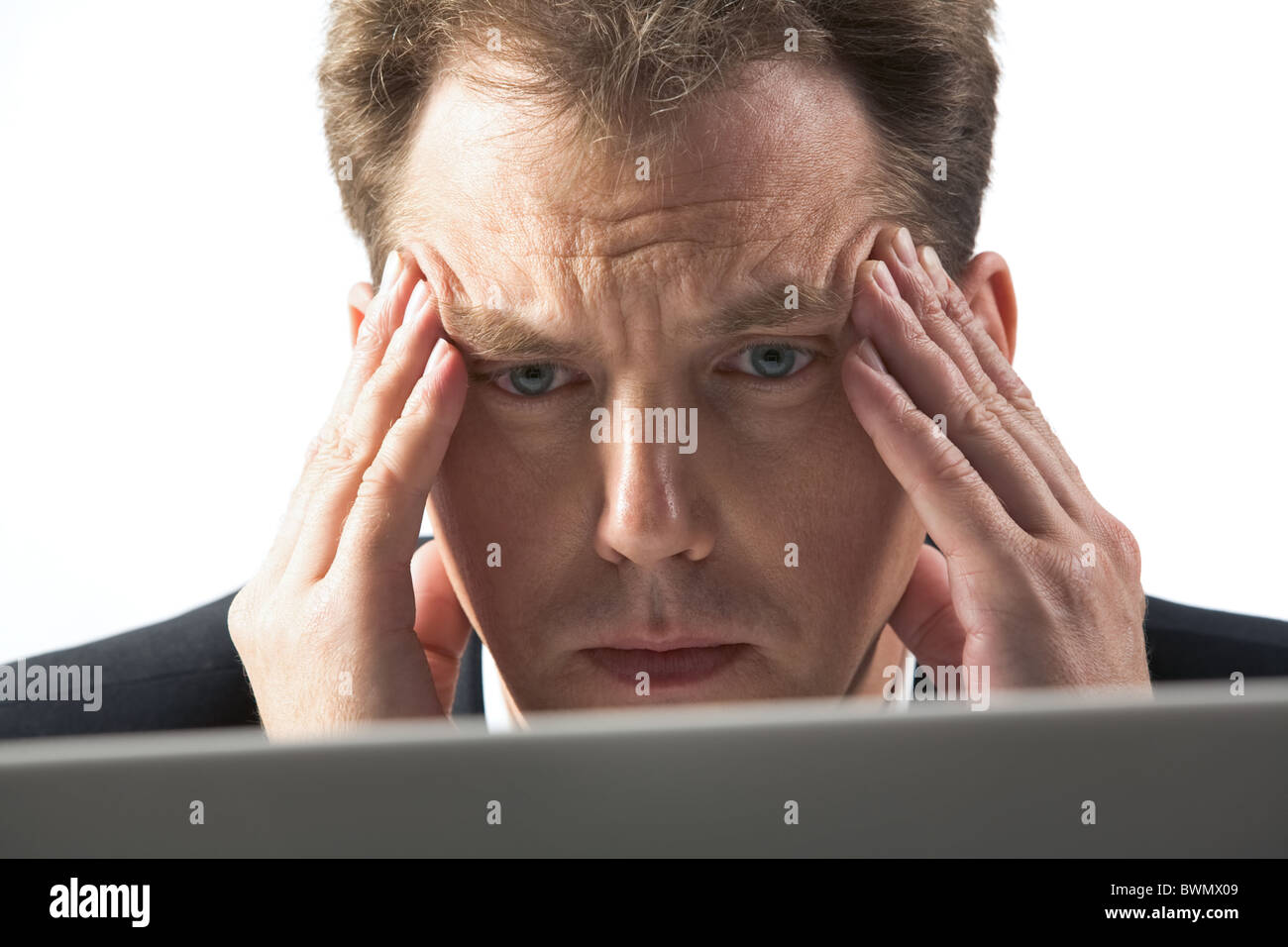 Photo of stressed businessman touching his head while thinking Stock ...