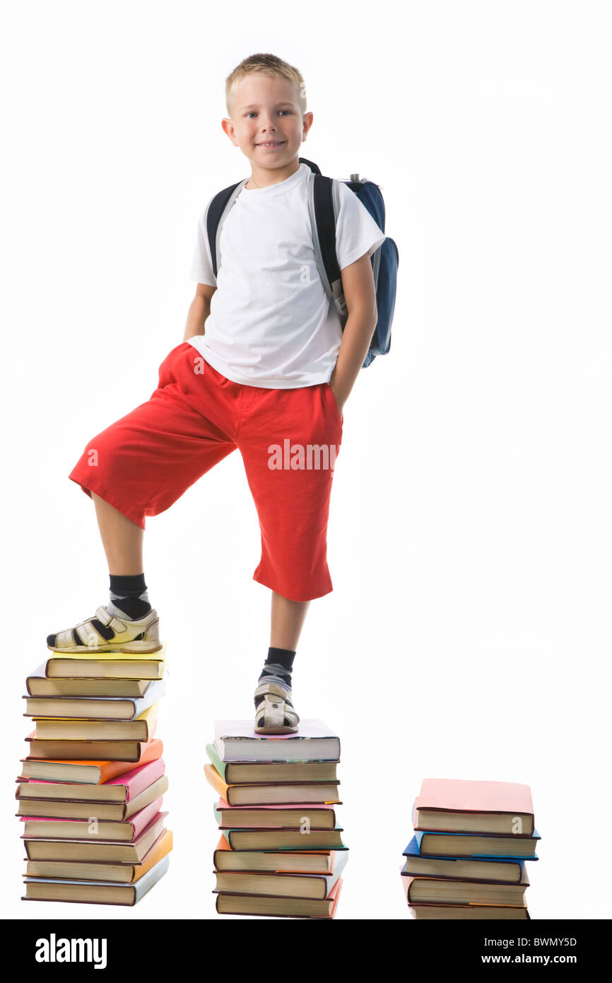 Diligent preschooler standing on the top of book stairs Stock Photo - Alamy