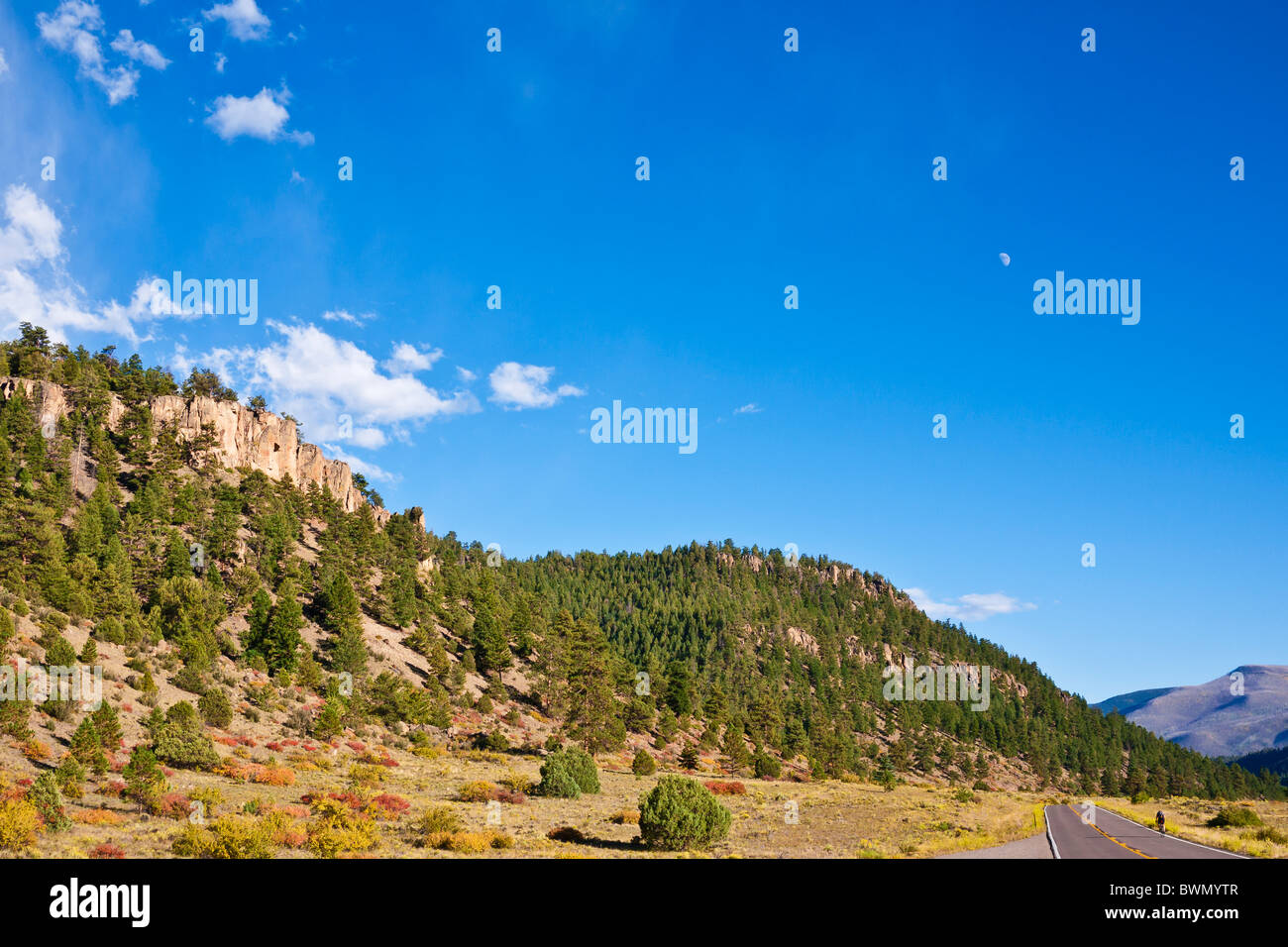 Cyclist passing the Rio Grande Palisades on Highway 149, Rio Grande ...