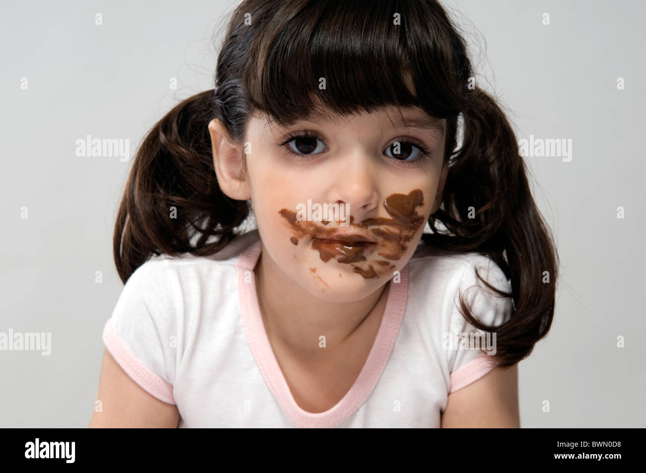 Girl with messy face, full of chocolate Stock Photo - Alamy