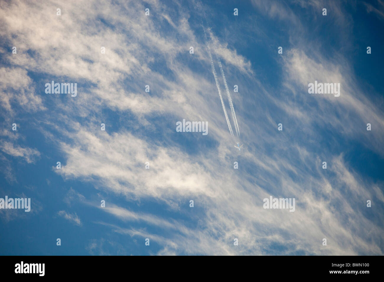 A jet flying through high level cloud Stock Photo - Alamy