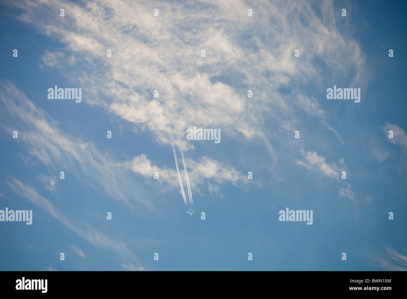 A jet flying through high level cloud Stock Photo - Alamy