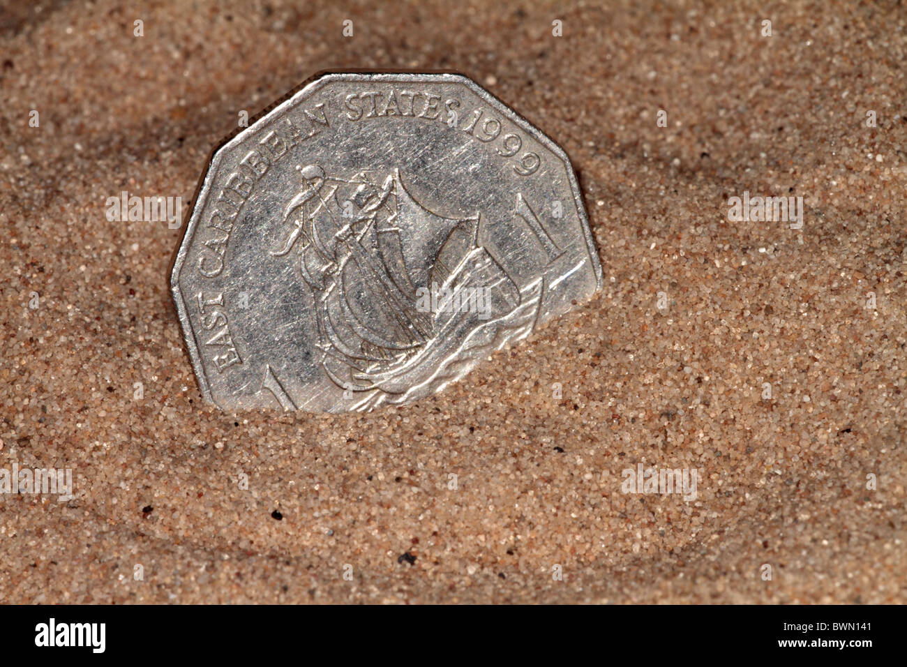 Caribbean coin in the sand Stock Photo - Alamy