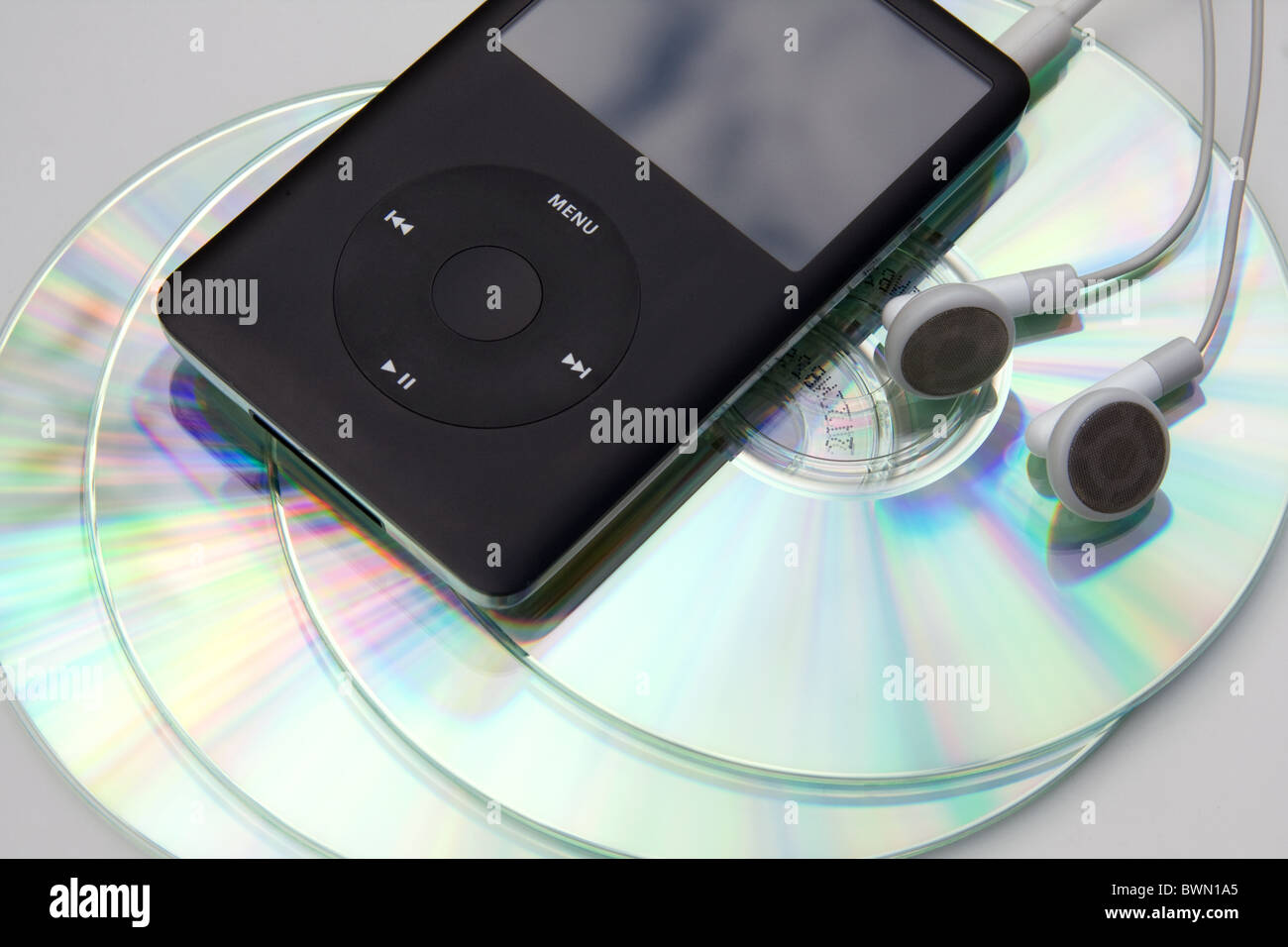 Apple iPod with ear phones and CDs Stock Photo - Alamy