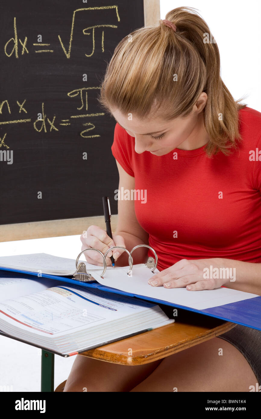 High school or college female student sitting by the desk at math class ...