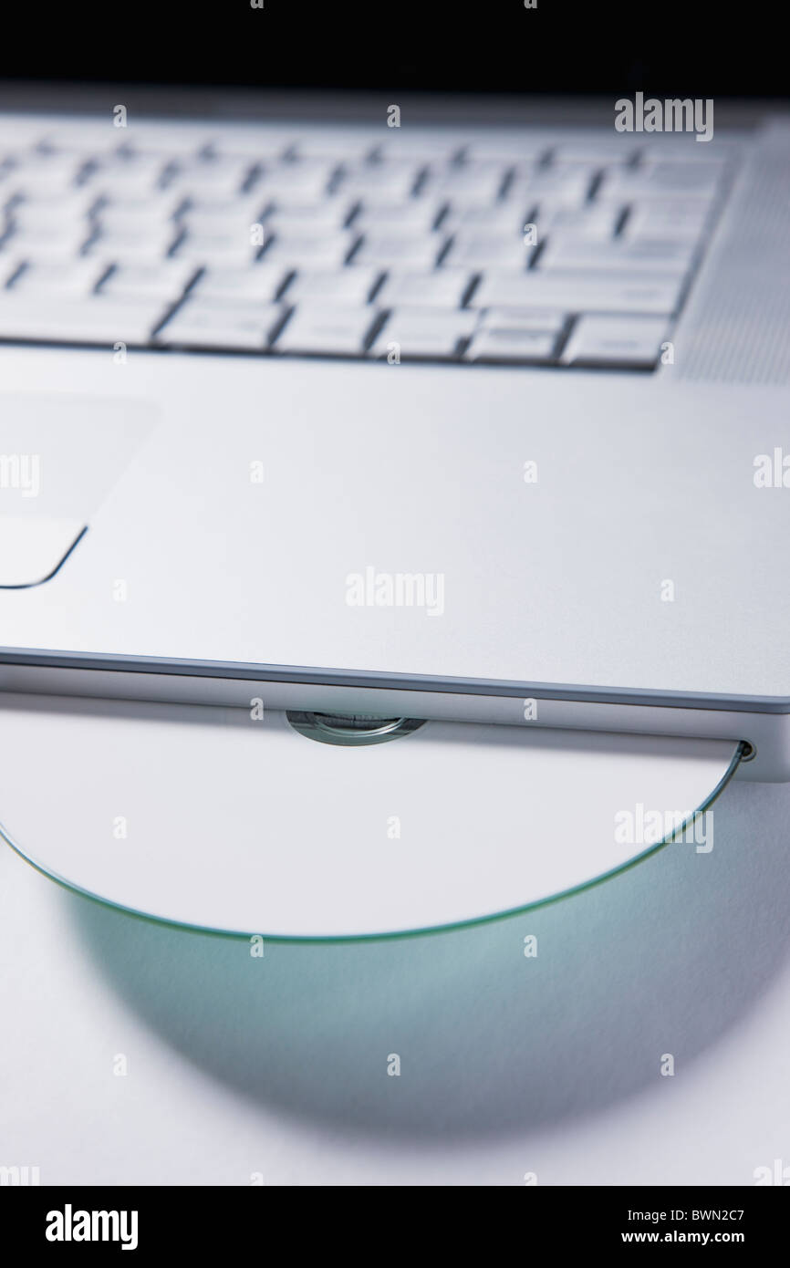 Close-up of laptop ejecting CD Stock Photo - Alamy