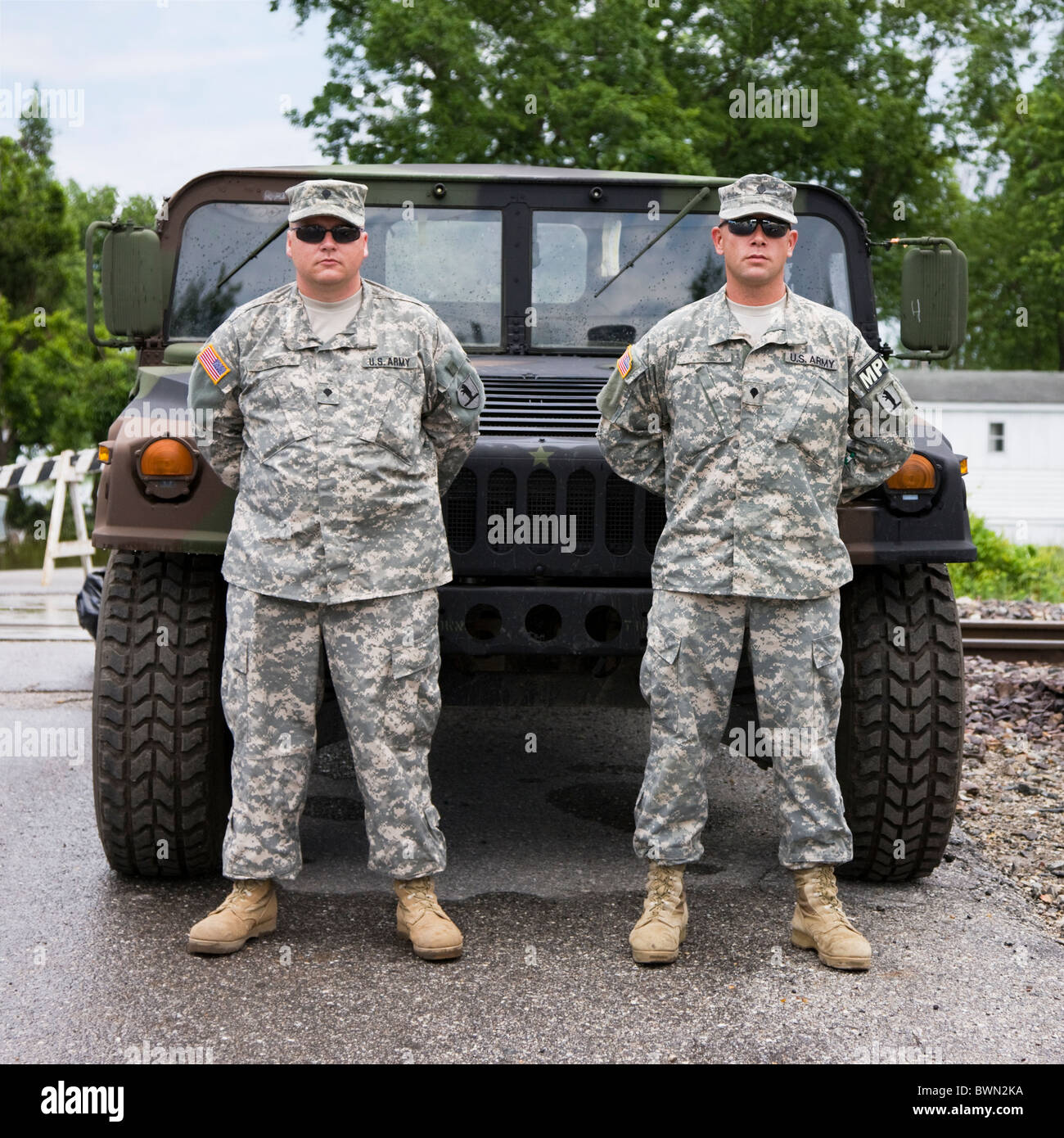 USA, Missouri, Portrait of two US soldiers standing in front of hummer ...