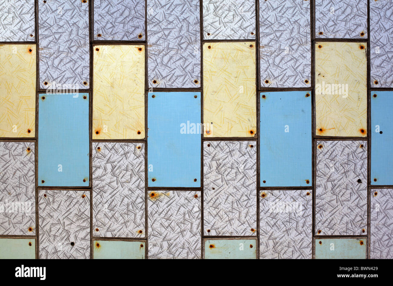 A wall covered with old plastic tiles of various colors Stock Photo - Alamy