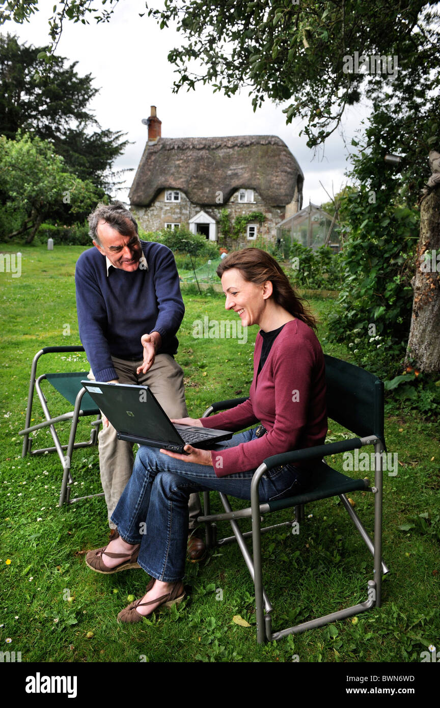 Owner of a thatched cottage getting online with a Wi-Fi connection UK ...