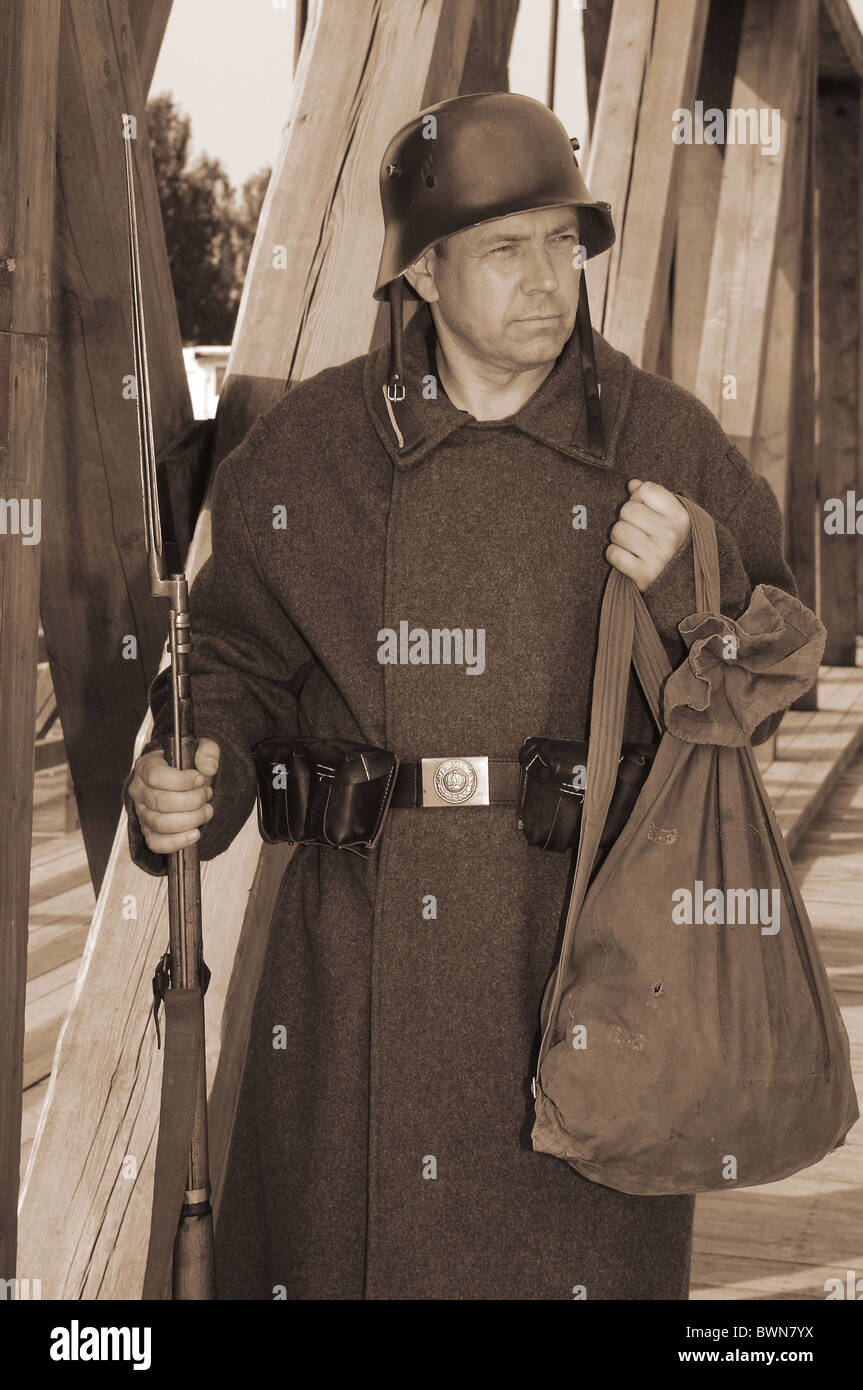 Old style picture with man in soldier uniform with weapon. Costume is ...