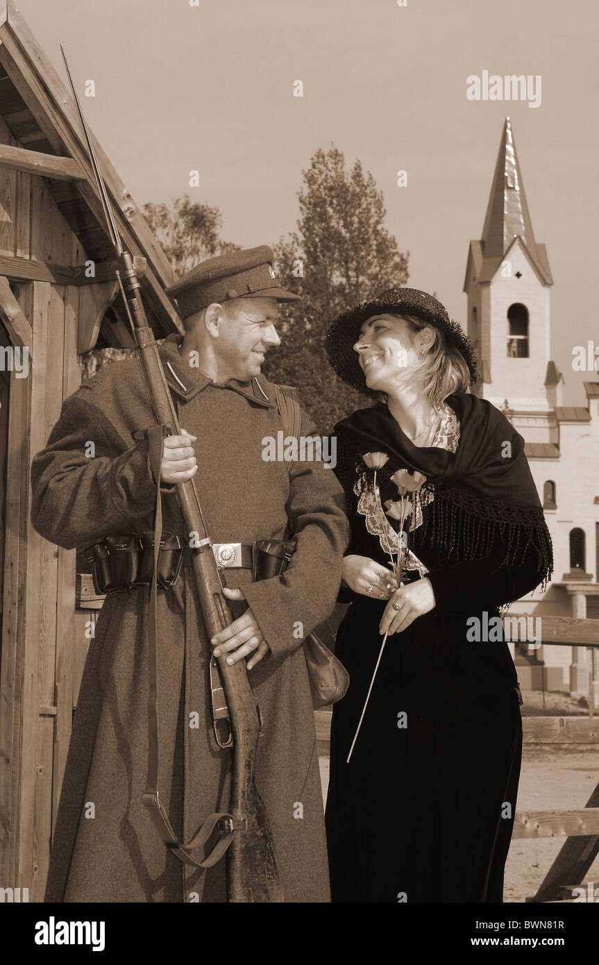 Old style picture with woman in dress and man in soldier uniform with ...