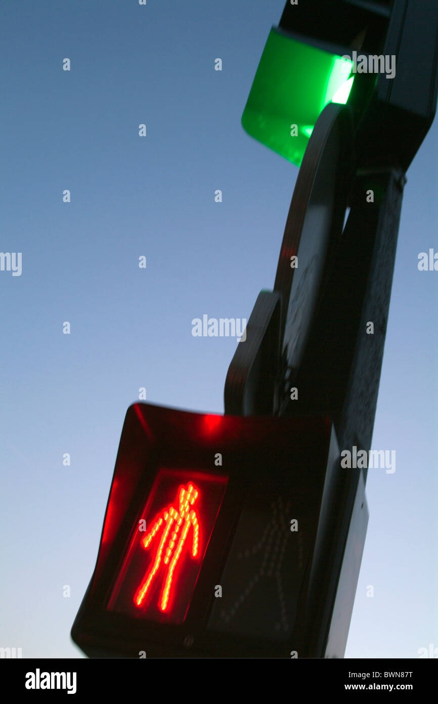 Pedestrian symbol on a traffic light turns red to warn pedestrians on a ...