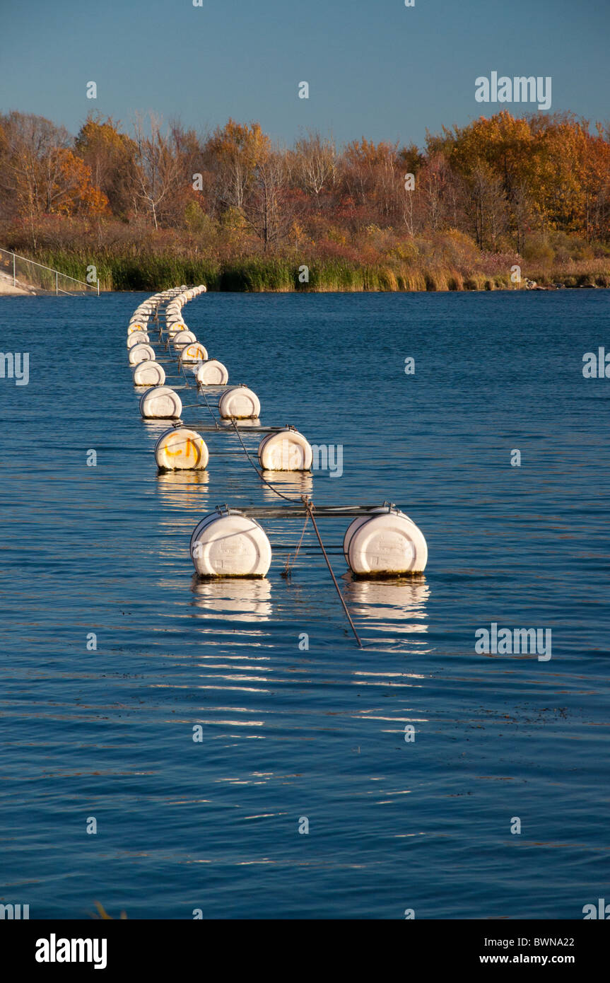 A string of safety barrels on the dam on the St. Lawrence River, west ...