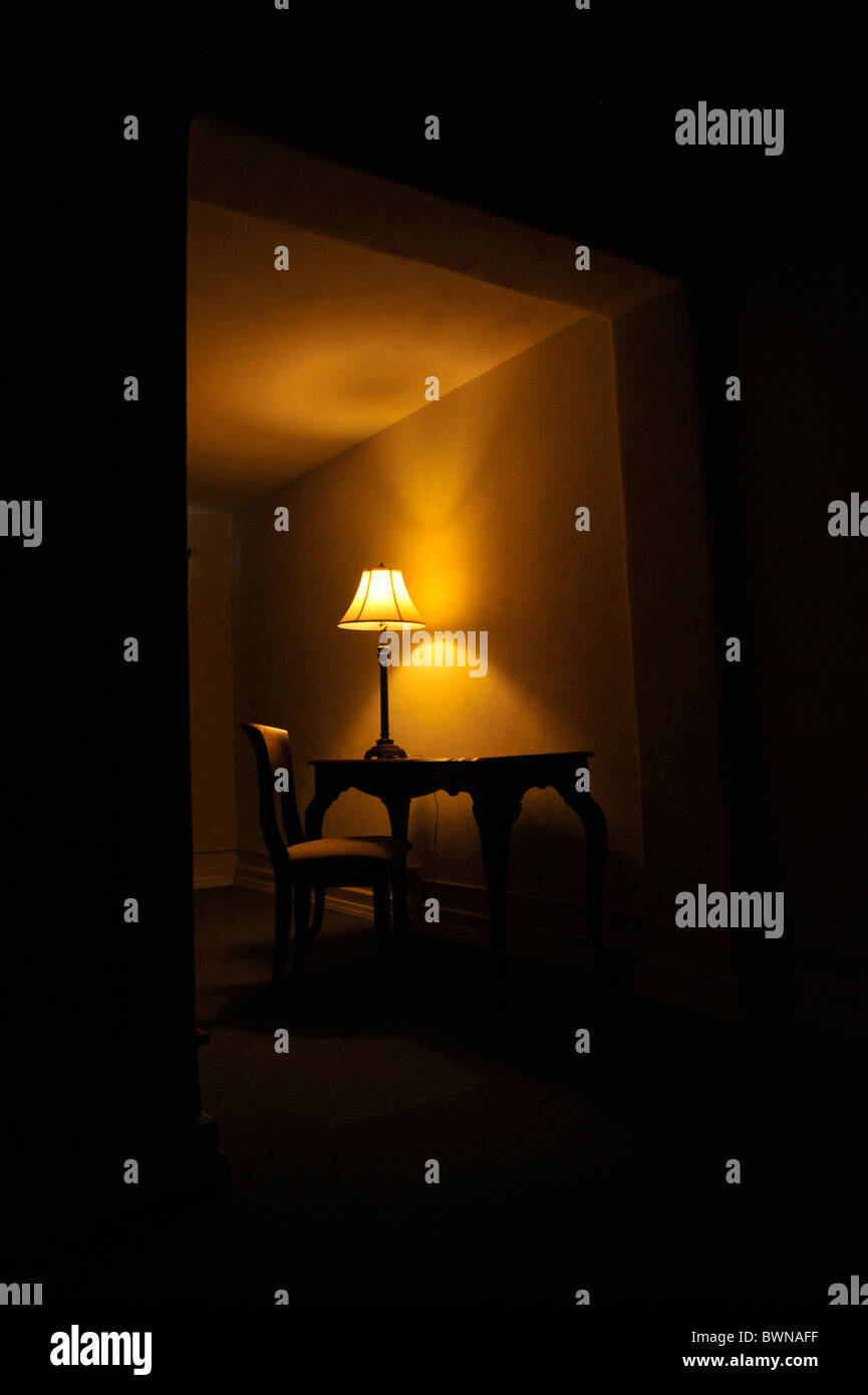 Seen through doorway, an antique chair, pushed back from elegant ...