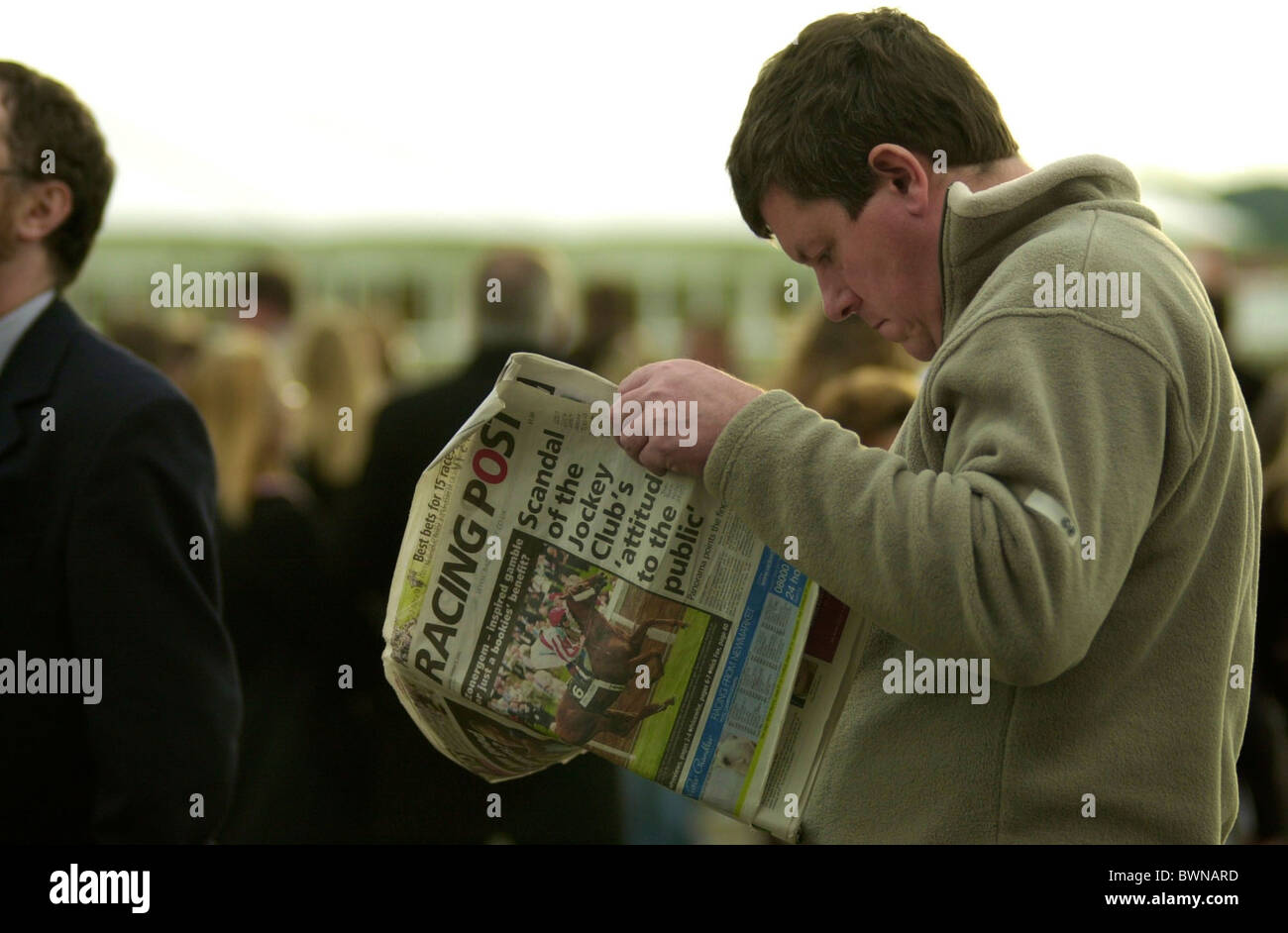 Man reading the Racing Post Newspaper at Newmarket Races at the Rowley ...