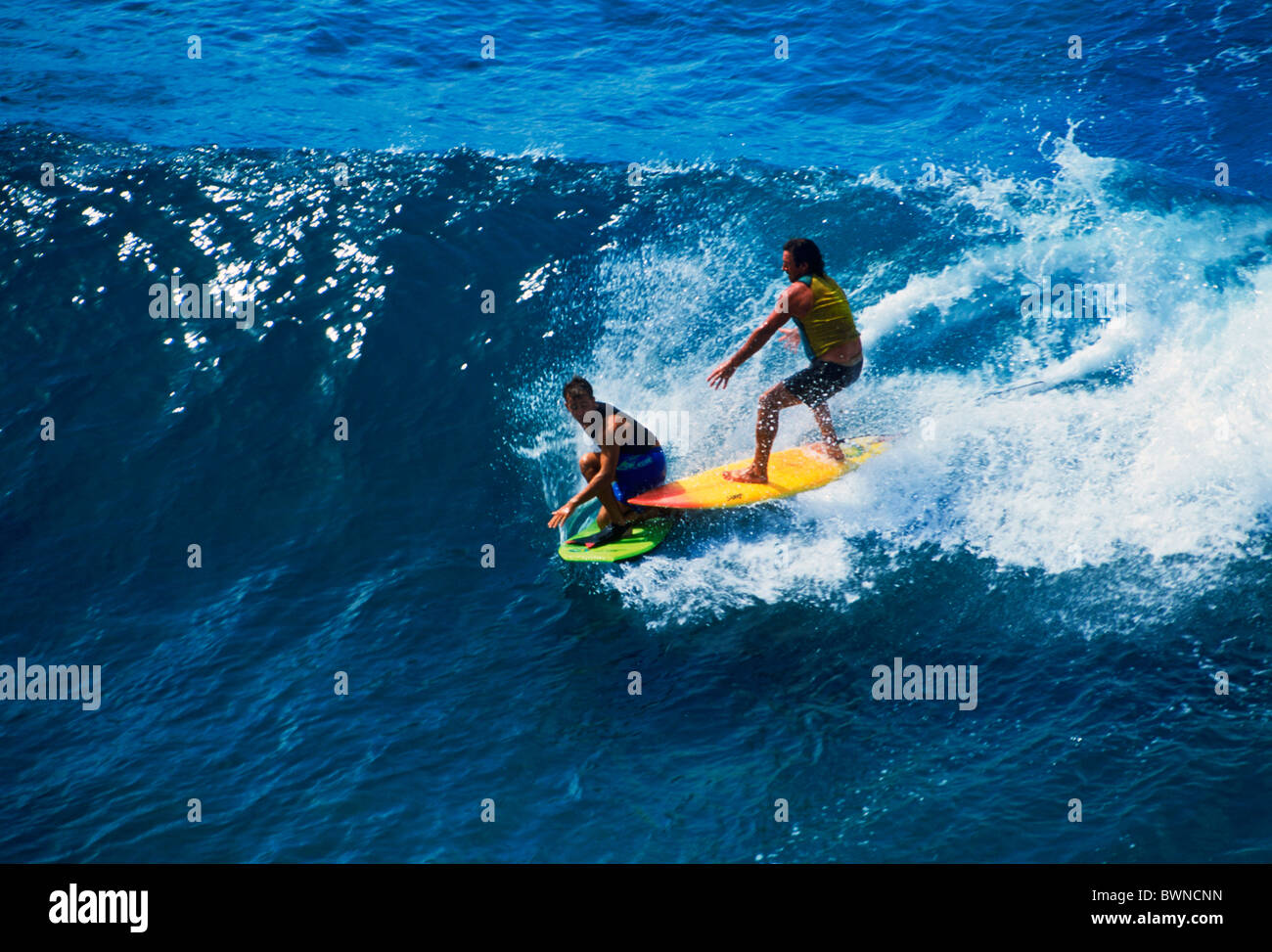 Two surfers ride wave hi-res stock photography and images - Alamy