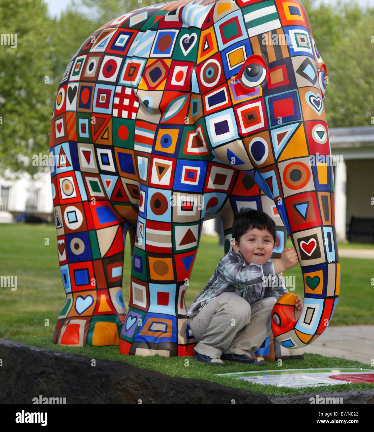 BOY LOOKS THROUGH MULTI-COLOURED ELEPHANT GREENWICH LONDON ENGLAND ...