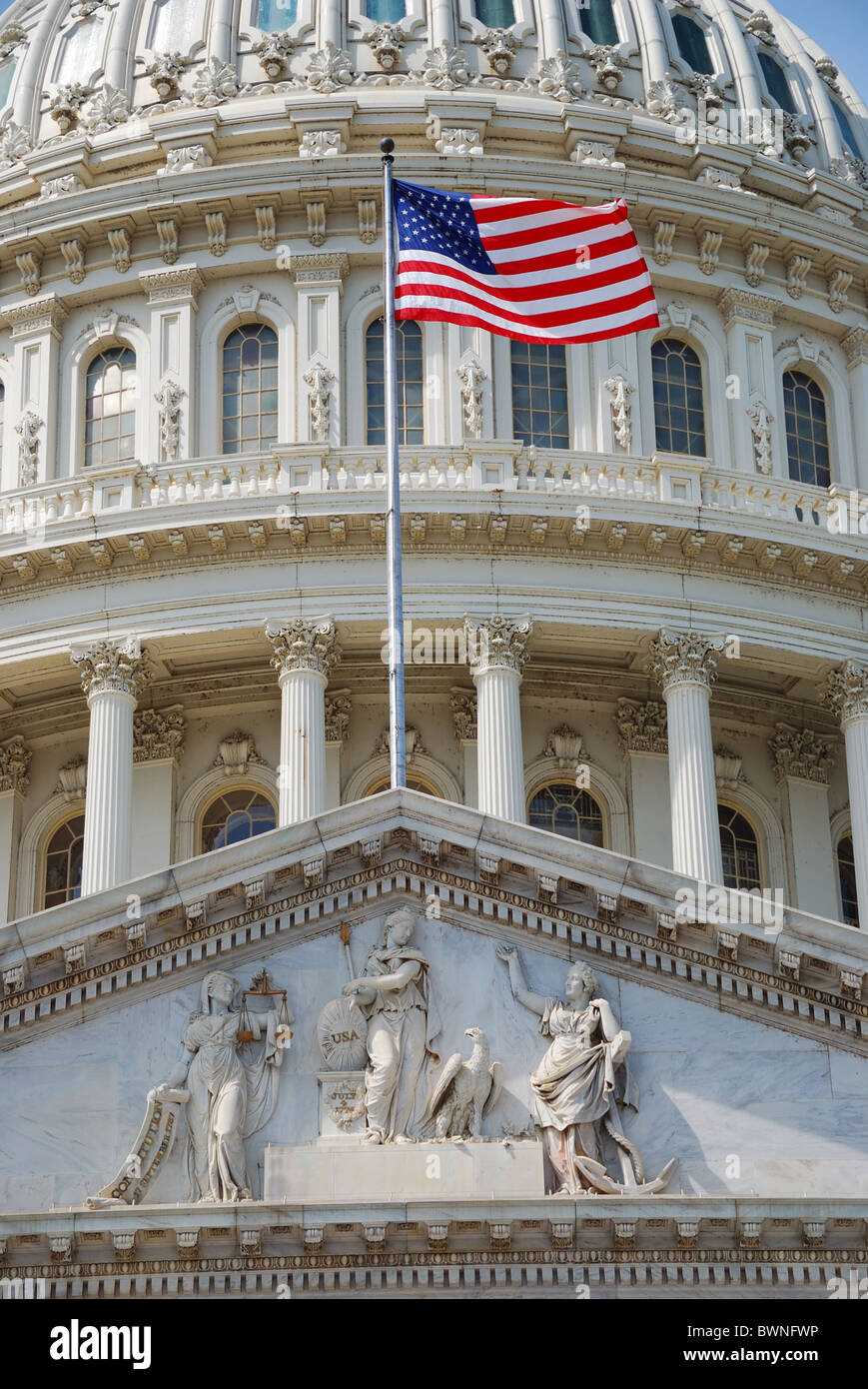 United States national flag in front of capitol building dome in ...