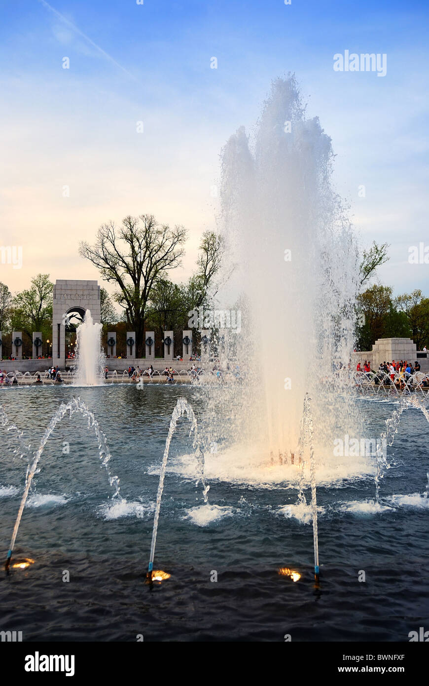 Fountain in World War II memorial, Washington DC, at dusk with lights ...